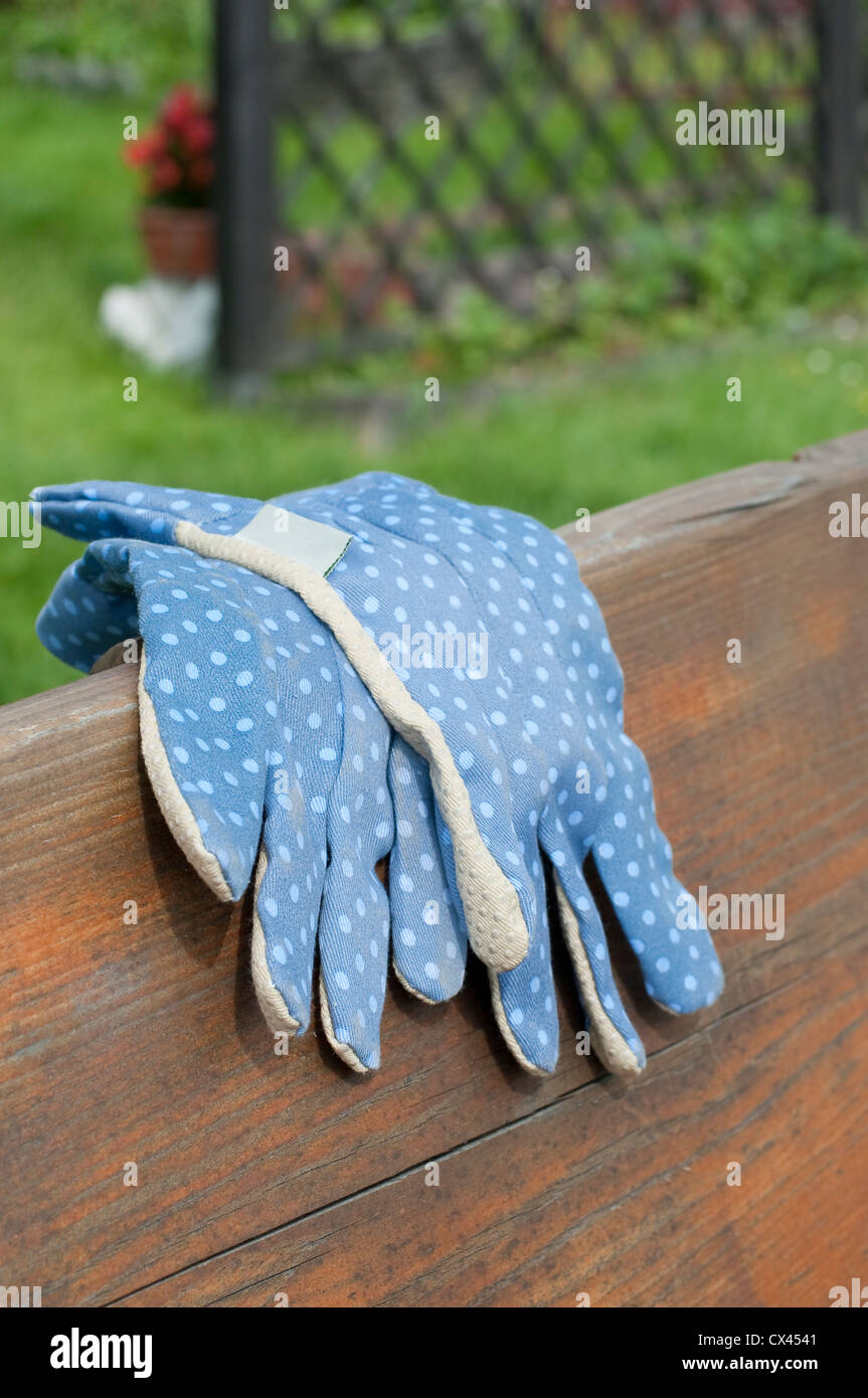 Garden gloves on bench in garden Stock Photo - Alamy