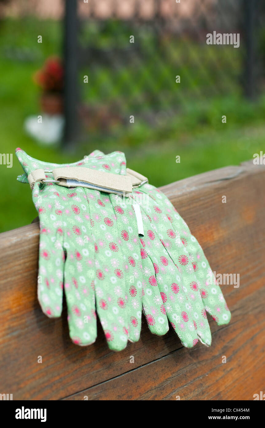 Garden gloves on bench in garden Stock Photo - Alamy