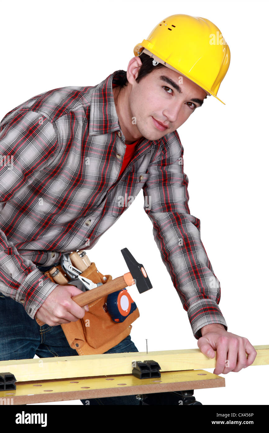 Man tapping in a nail Stock Photo - Alamy