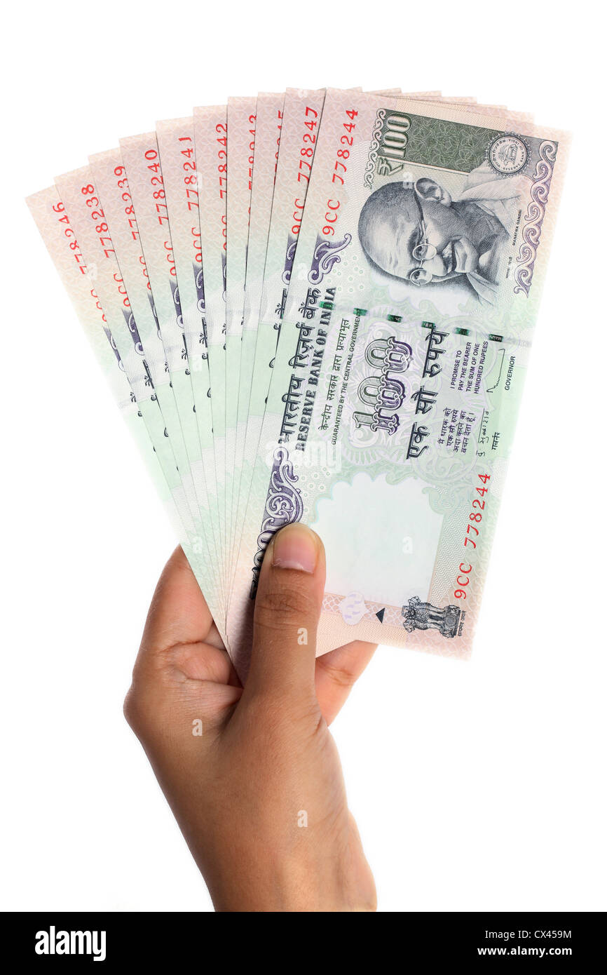 Hand holding Indian rupee notes against white background Stock Photo ...