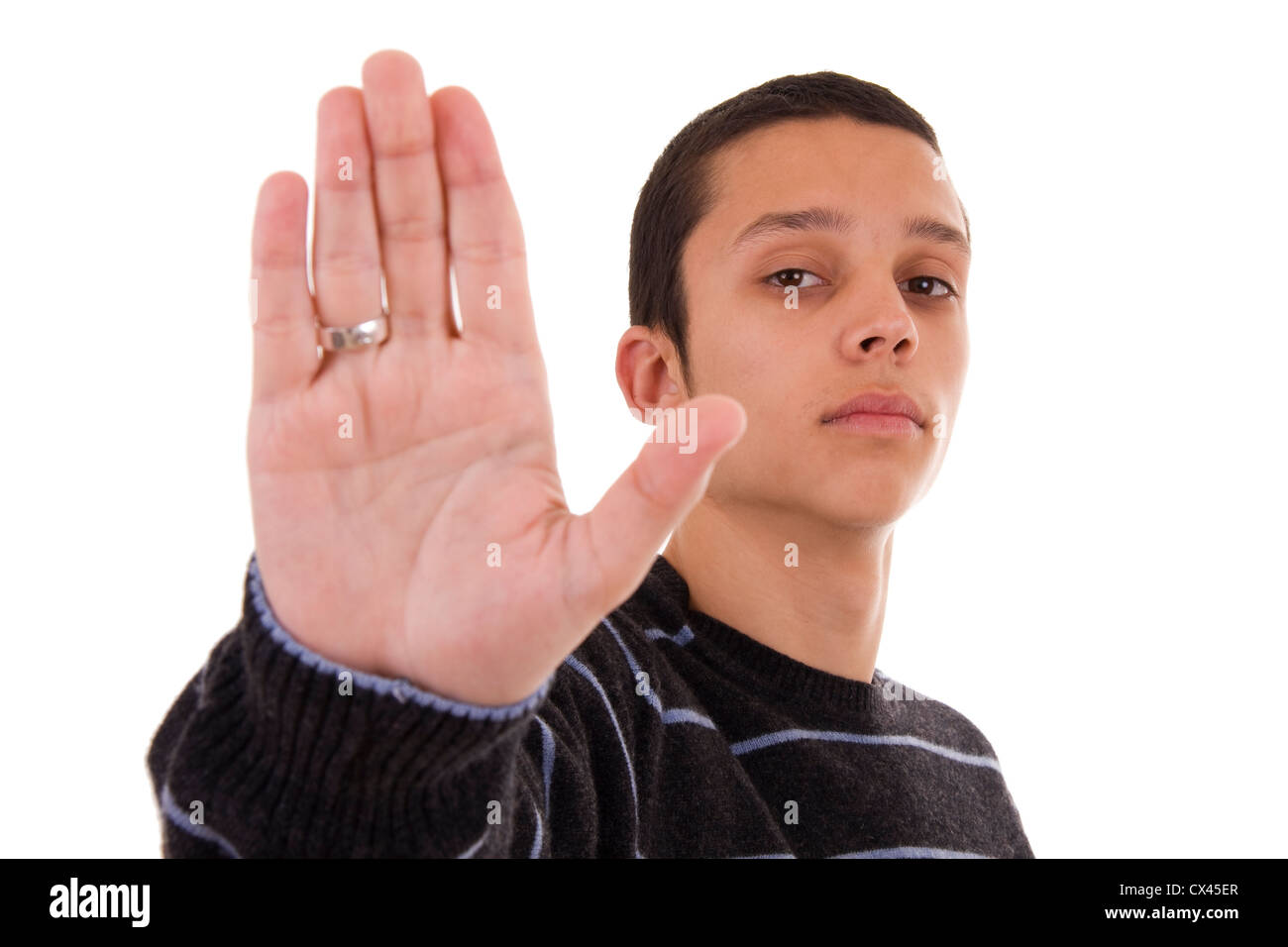 A young man holding up his hand in a stop sign Stock Photo - Alamy