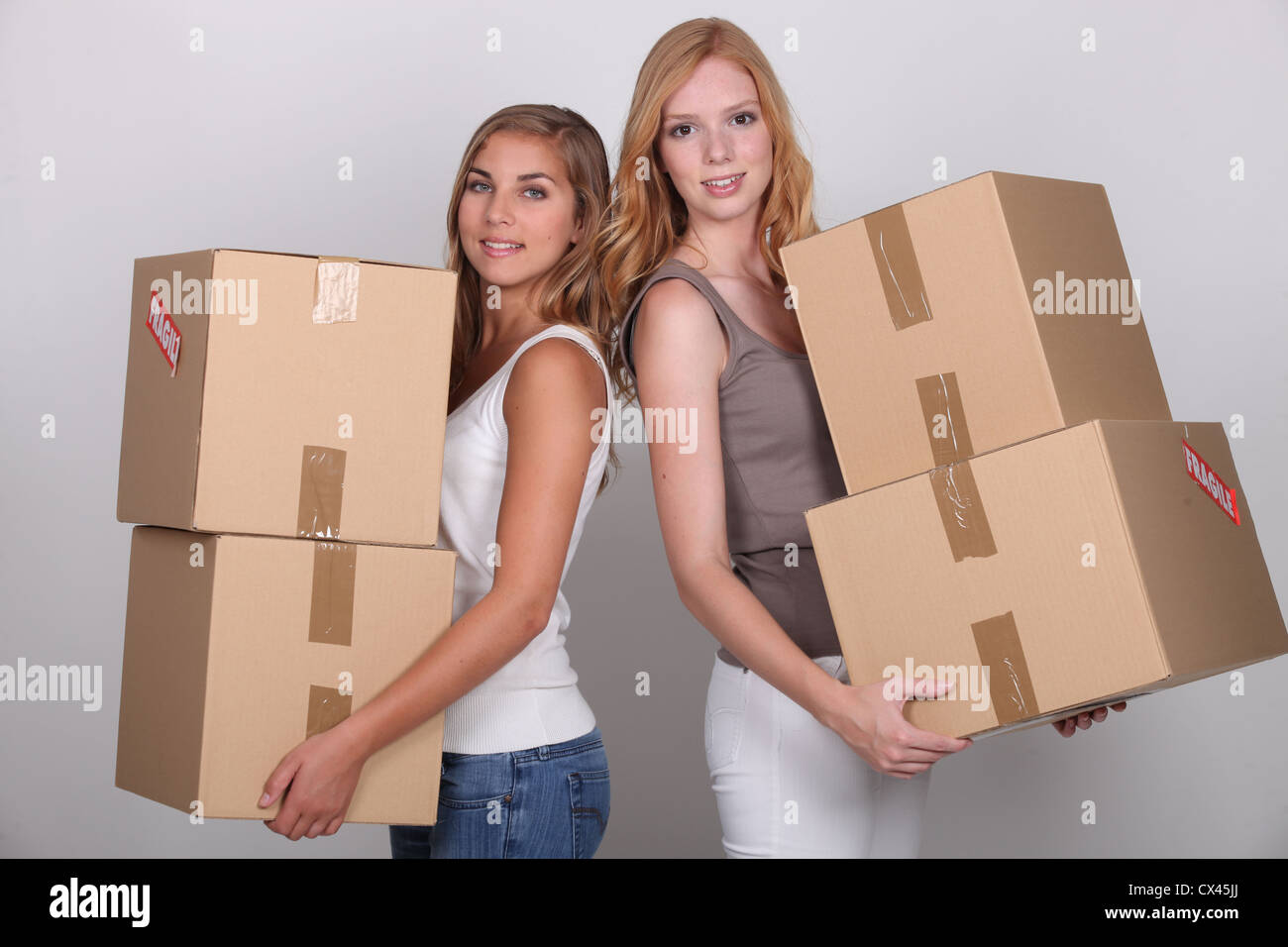 Girls carrying boxes Stock Photo - Alamy