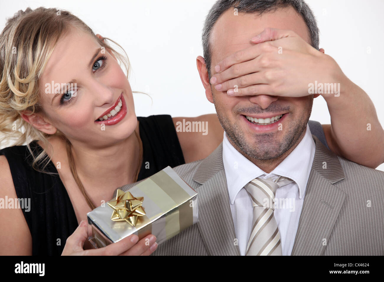 Couple with a surprise gift Stock Photo - Alamy