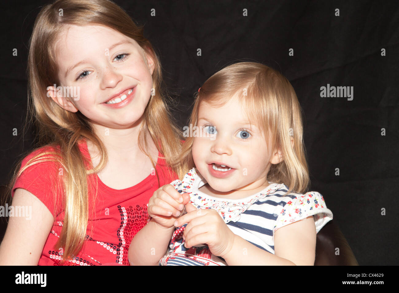 two happy girls - sisters Stock Photo - Alamy