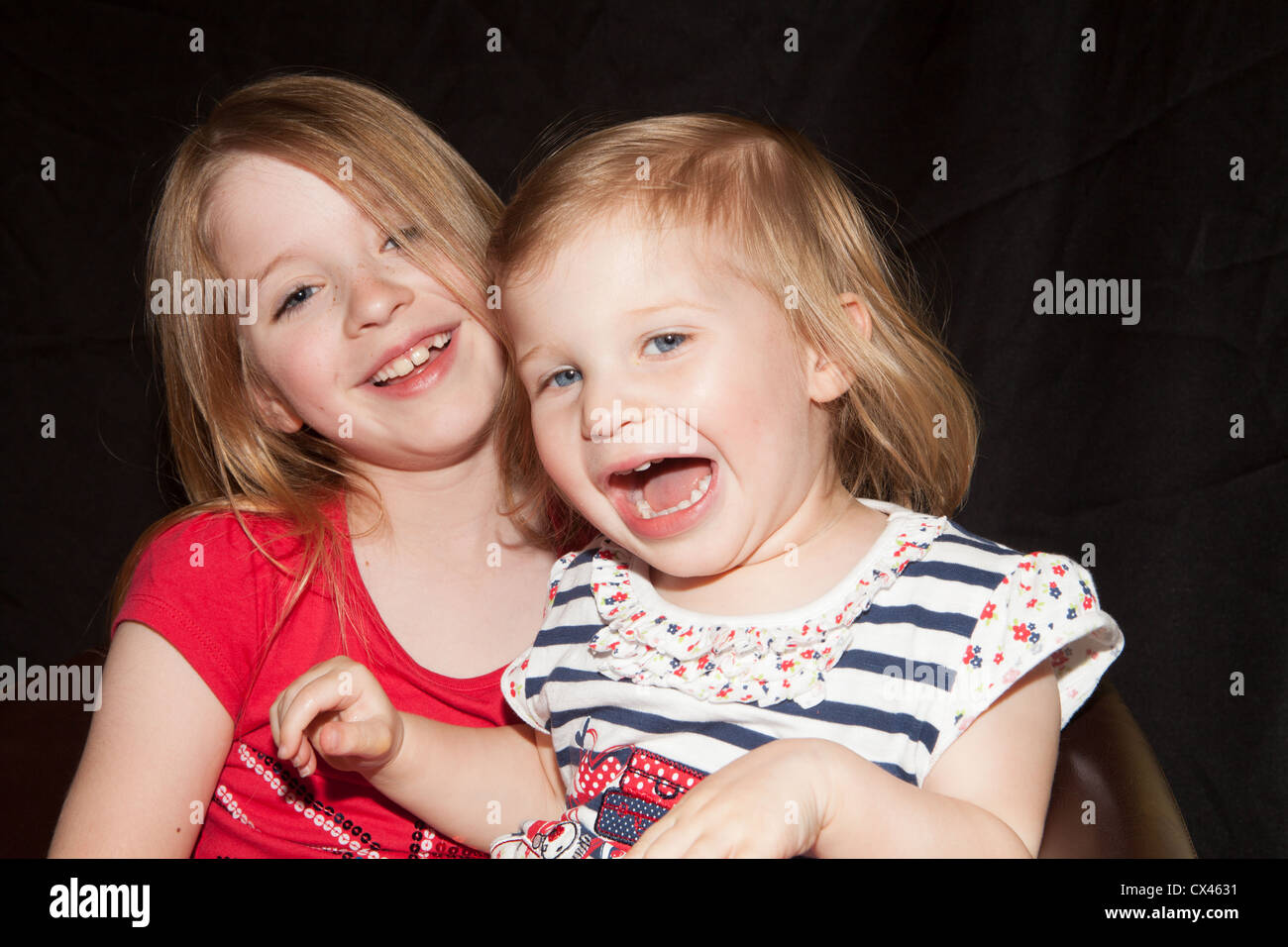 two happy girls - sisters Stock Photo - Alamy