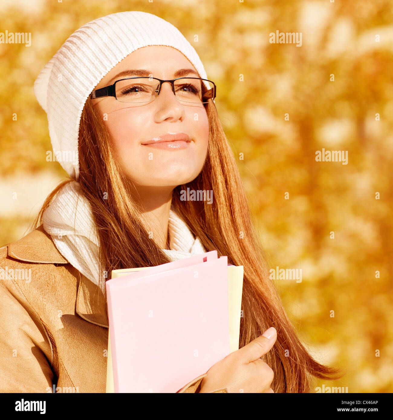 Picture of romantic student girl with textbook on yellow foliage ...