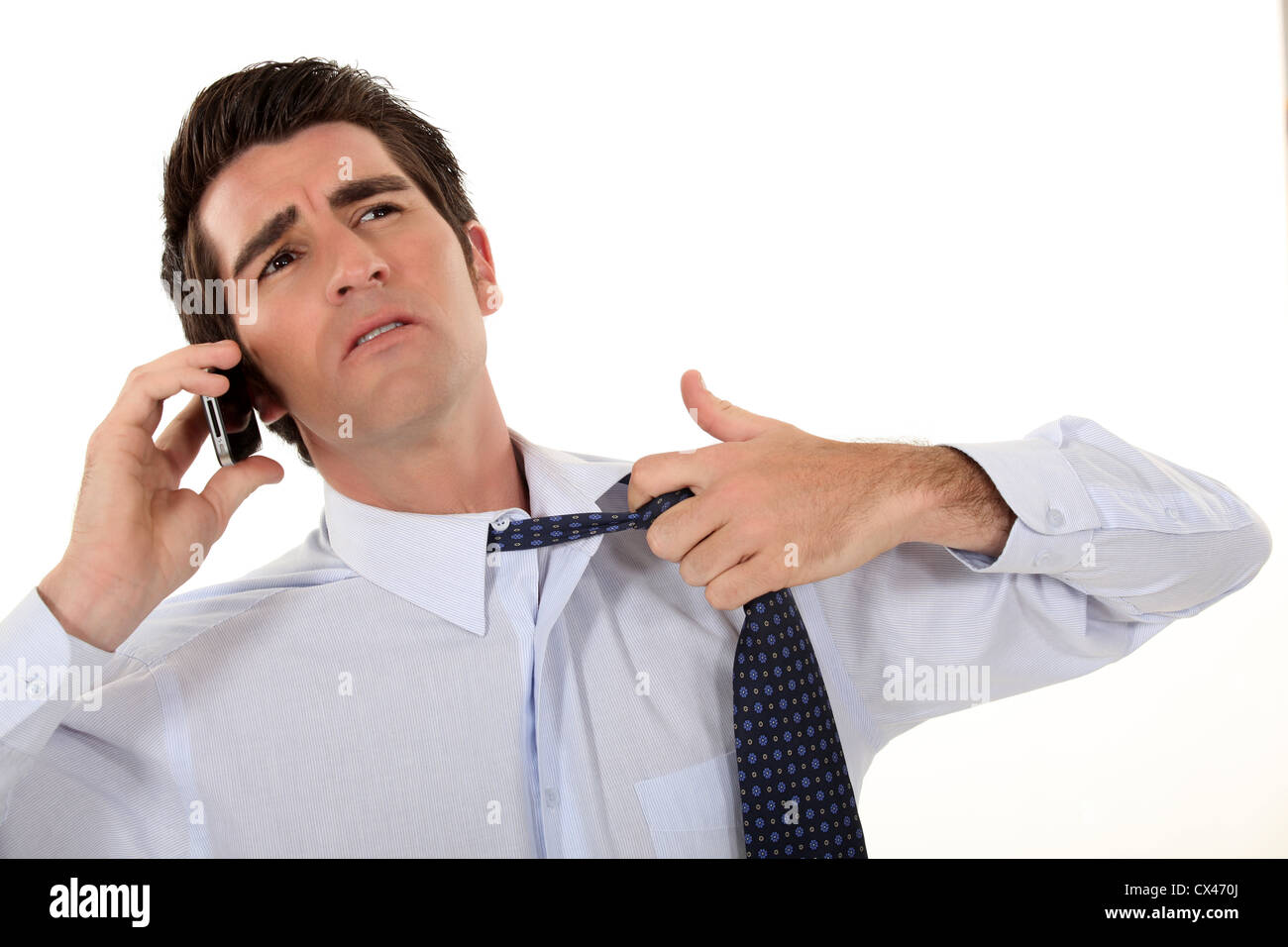 Man undoing his tie Stock Photo - Alamy