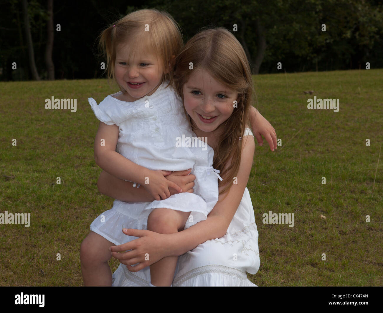 two happy girls - sisters Stock Photo - Alamy