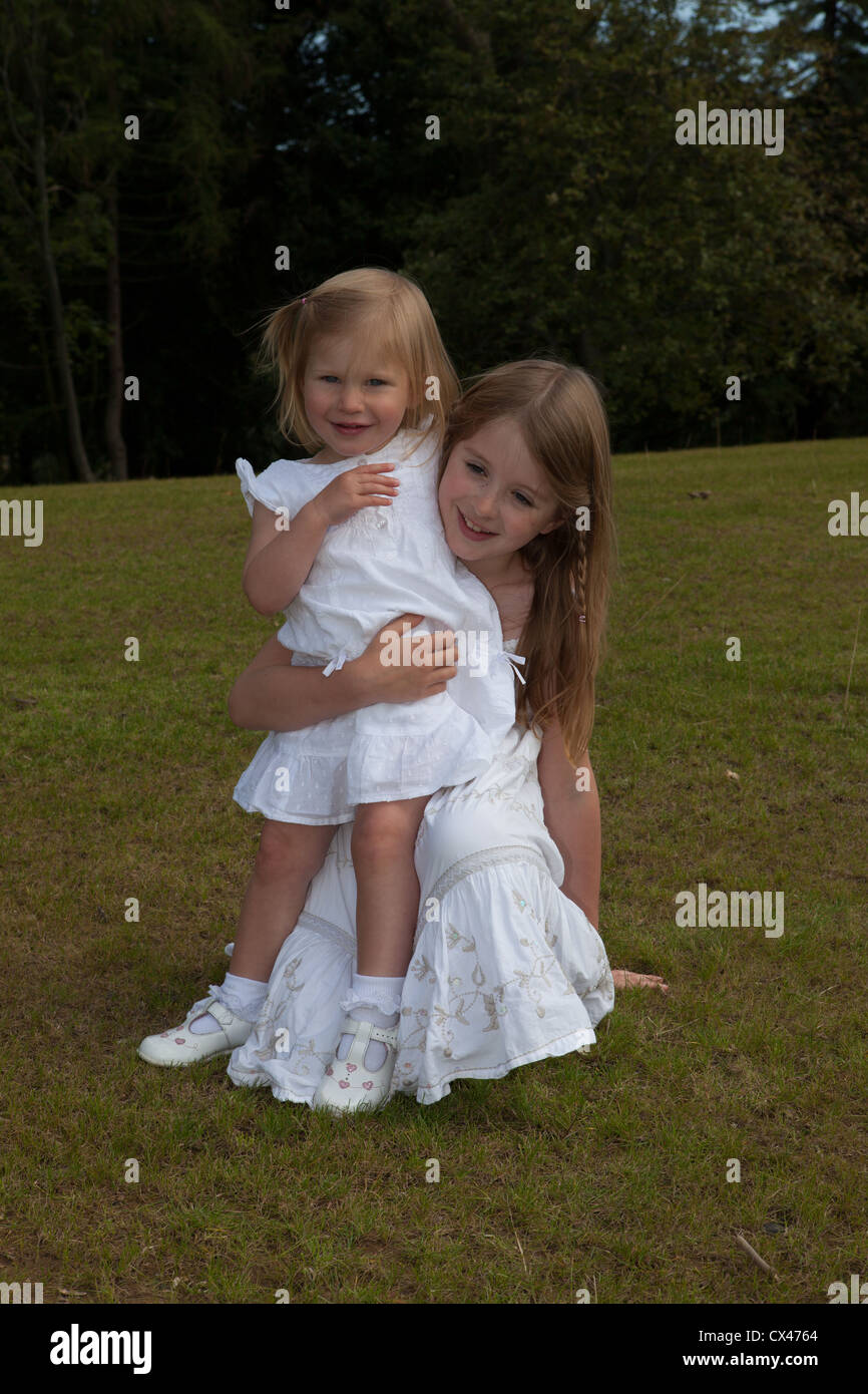 two happy girls - sisters Stock Photo - Alamy