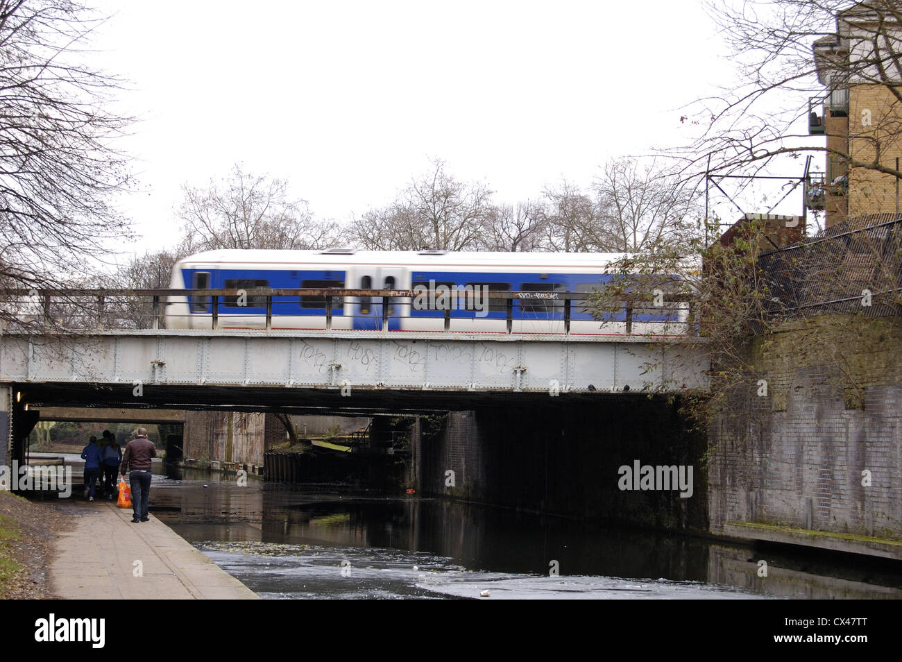 Train crossing railway bridge over canal in London, England Stock Photo ...
