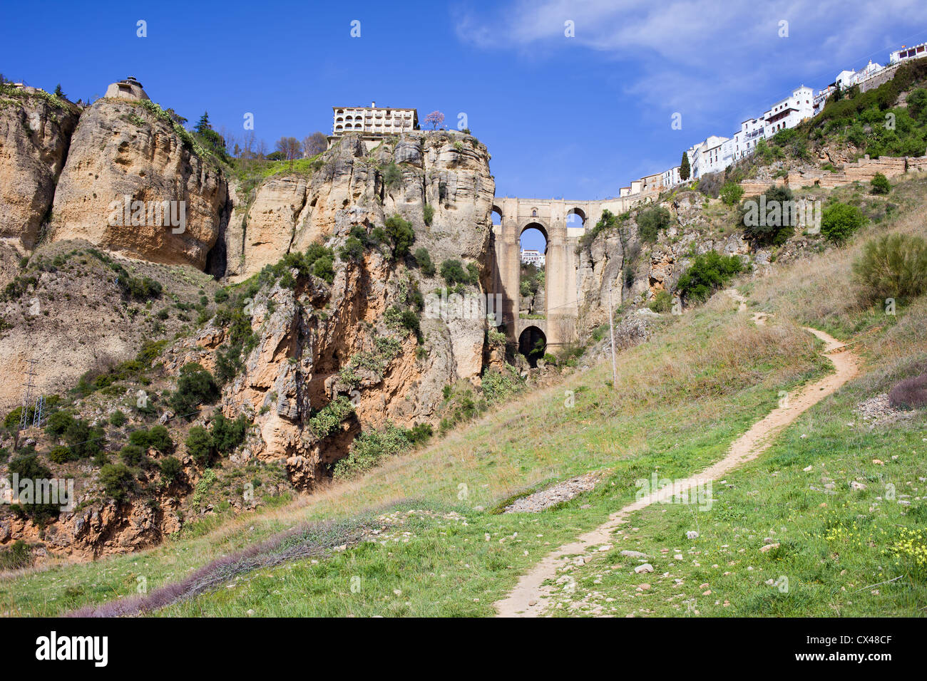 Path through a meadow leading to the New Bridge (Spanish: Puente Nuevo ...