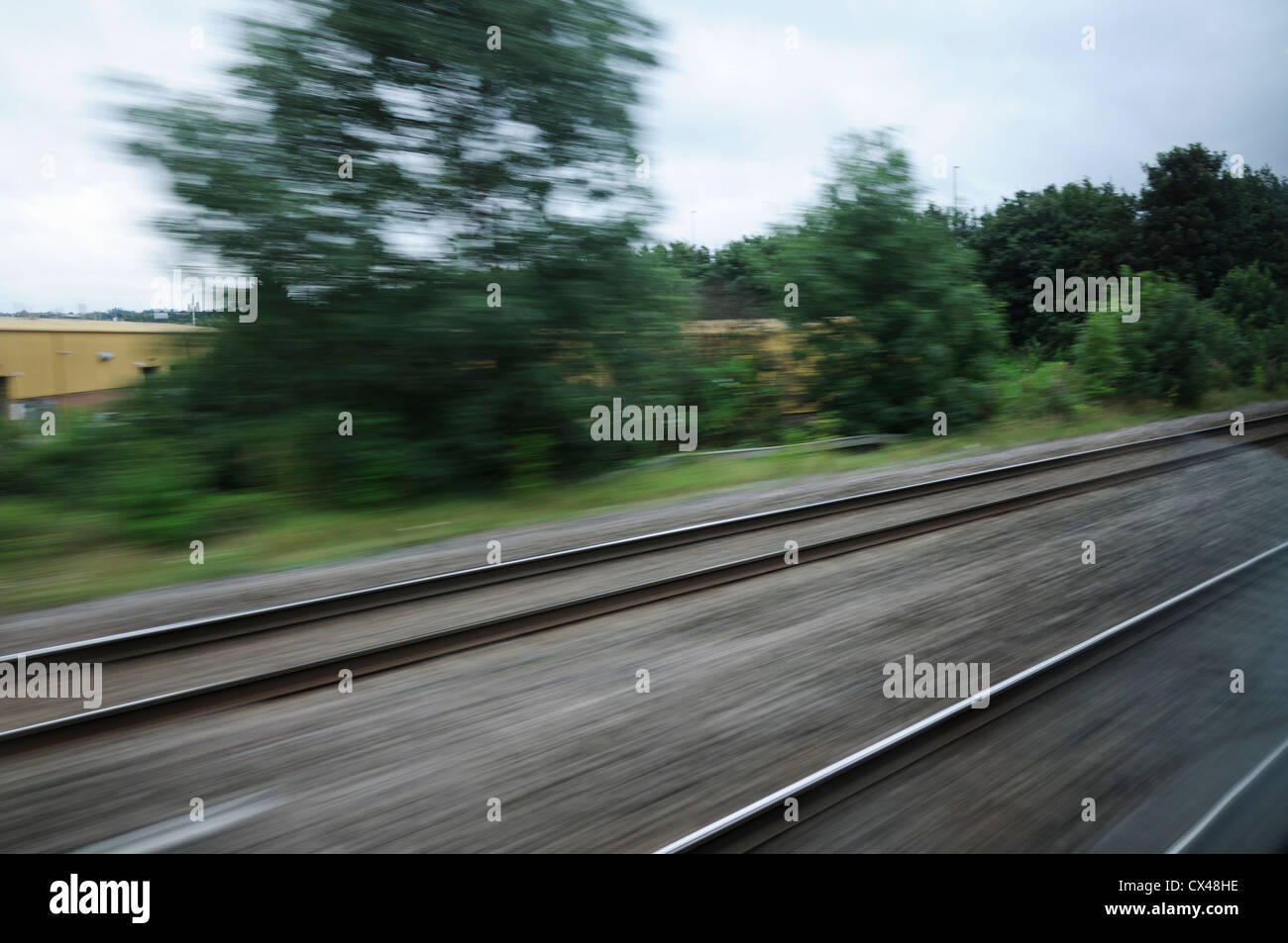 Looking out from a train window of a speeding train Stock Photo - Alamy