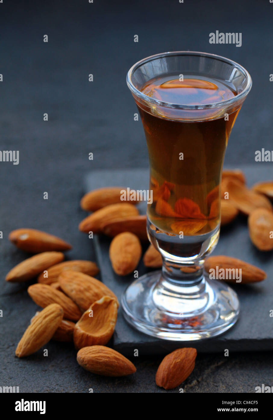 Almond liquor amaretto with whole nuts on a dark background Stock Photo ...