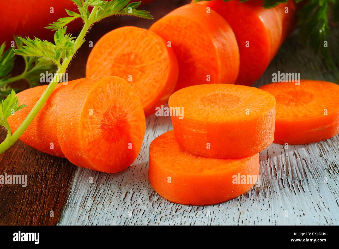 short carrot on wood background Stock Photo - Alamy