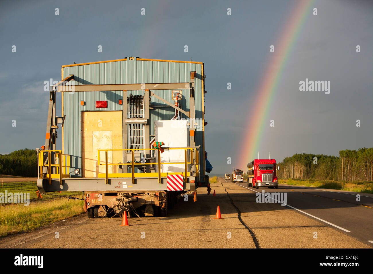 Trucks haul an oversize loadof tar sands equipment, on the road towards ...