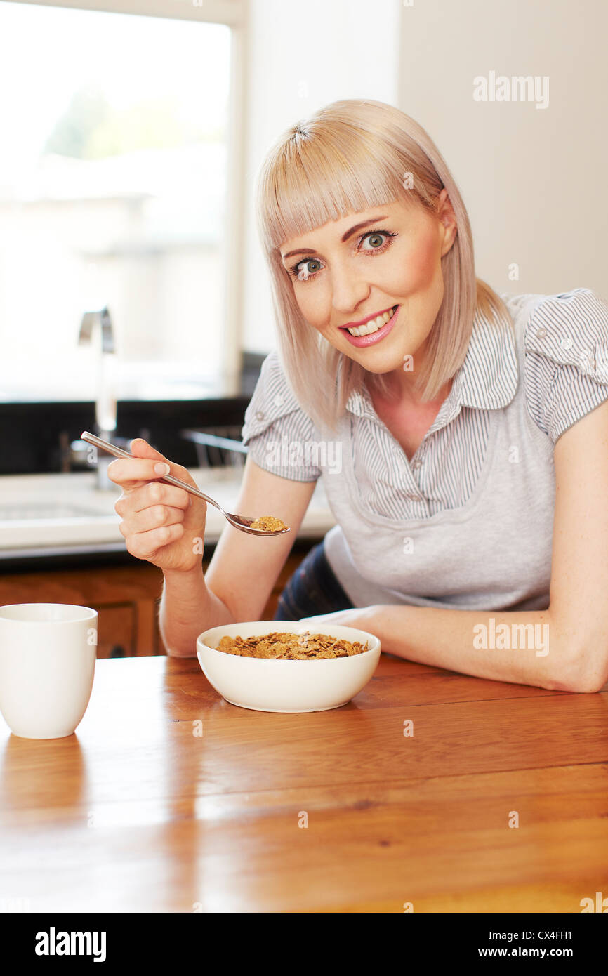 Girl eating Cornflakes breakfast Stock Photo - Alamy