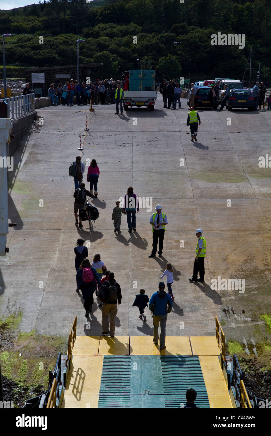 Passengers disembark the CalMac ferry at the Isle of Eigg, Small Isles ...