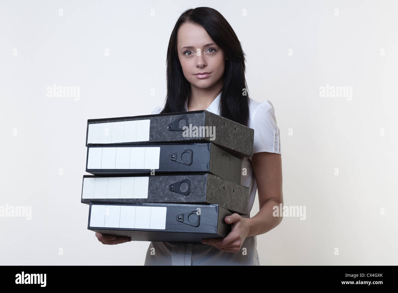 young business woman holding a large stack of folders Stock Photo - Alamy