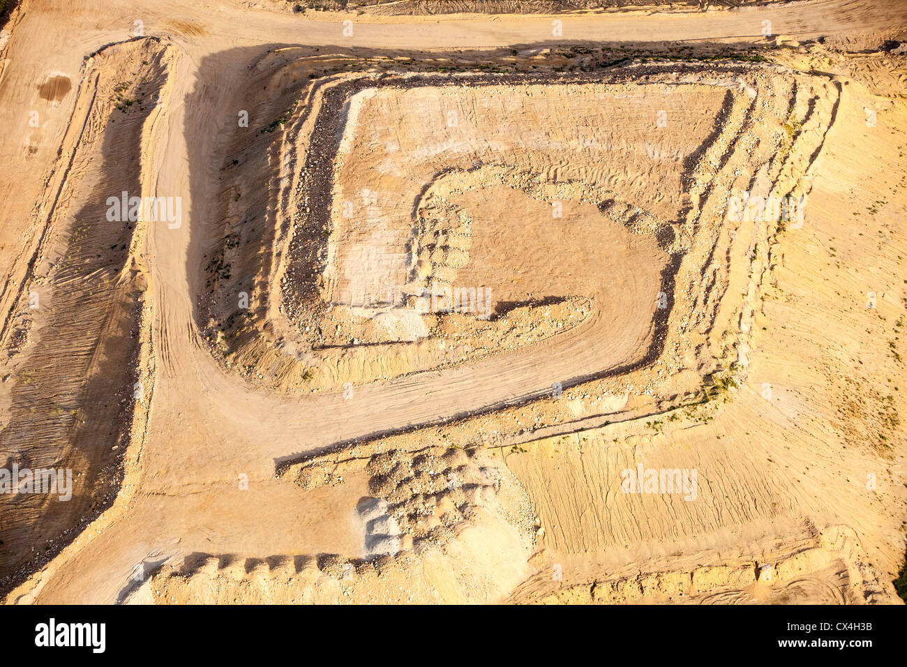 Soil overburden being removed to get at the tar sands below, in a mine ...