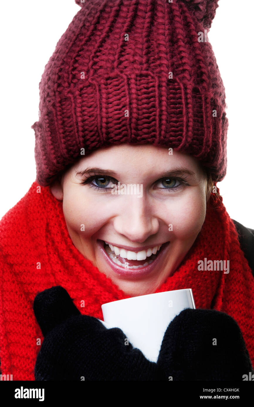 woman looking cold in winter clothes drinking a hot drink to keep warm ...