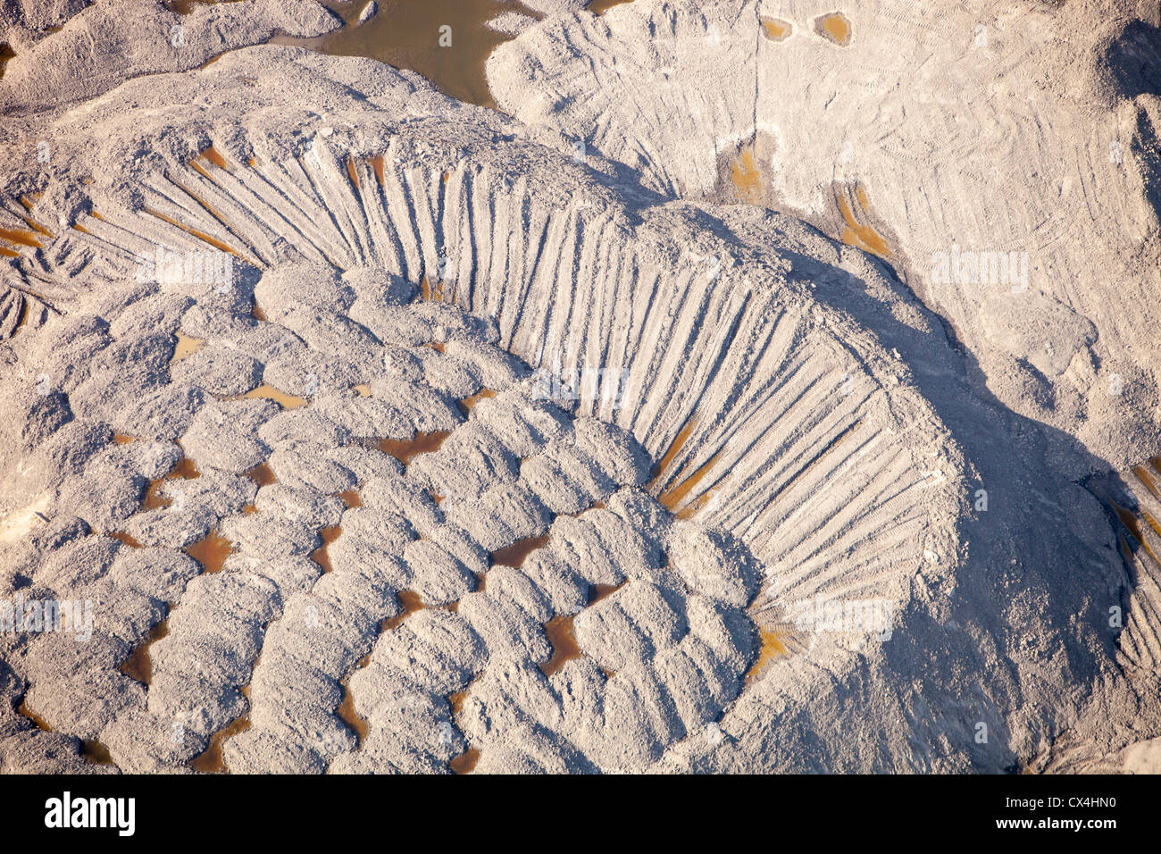 Soil overburden being removed to get at the tar sands below, in a mine ...
