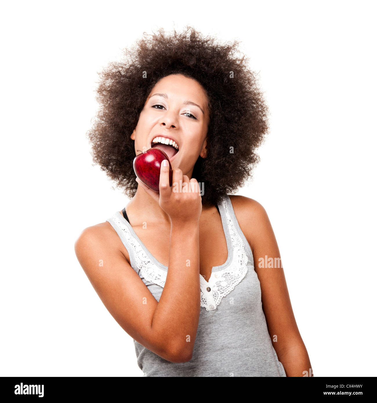 African American young woman holding and eating an apple Stock Photo ...