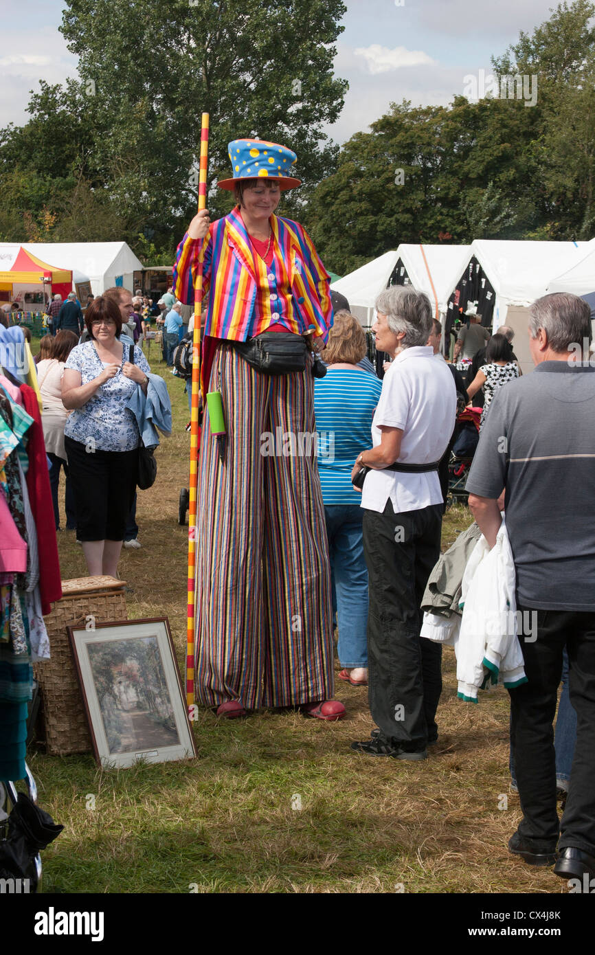 Lady on stilts at country fair Stock Photo - Alamy