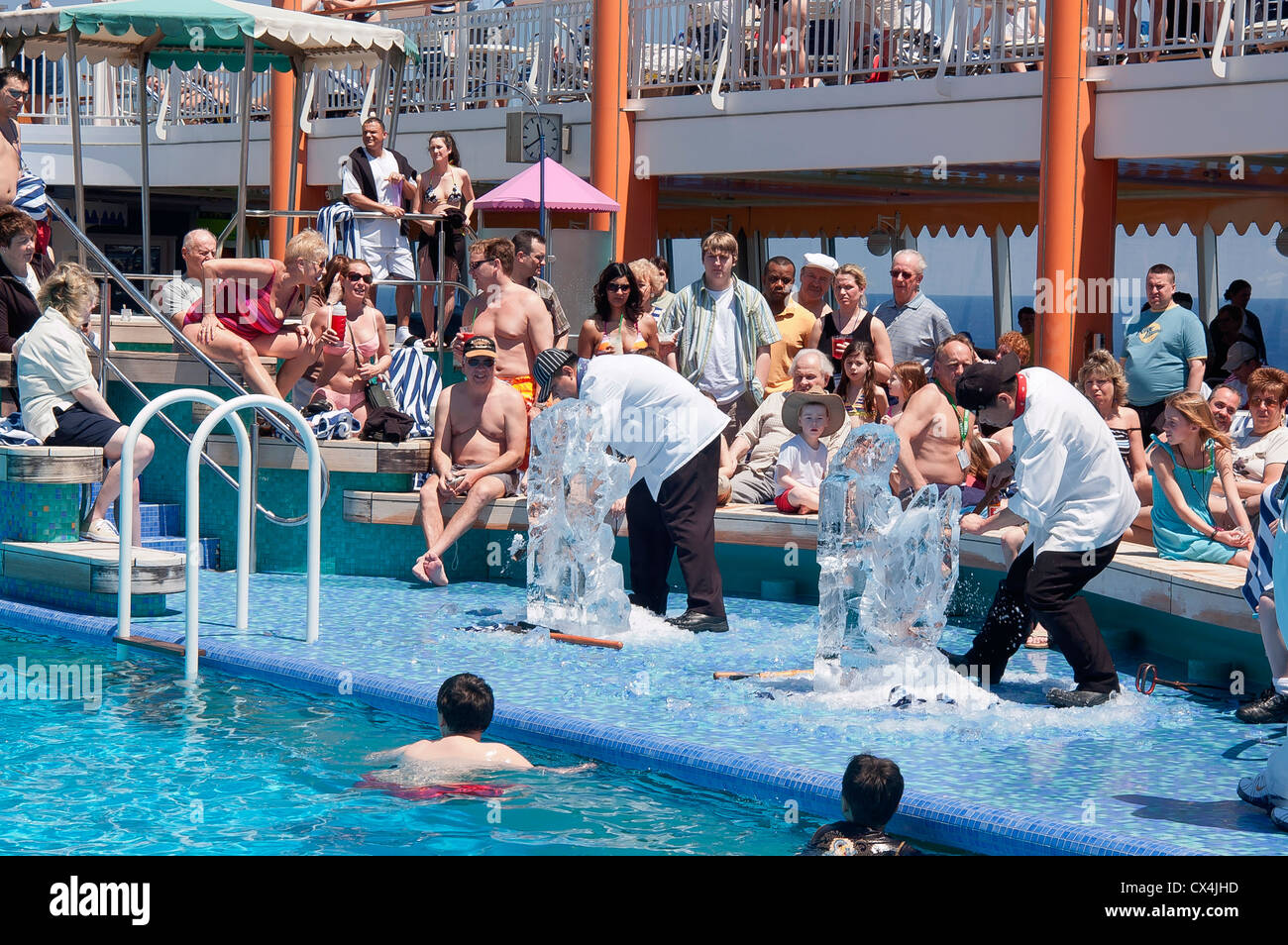 Two employee working on ice sculpture during Ice carving demonstration ...