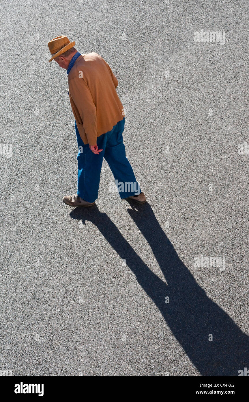 Old man (from above) crossing street + long shadow - France Stock Photo ...