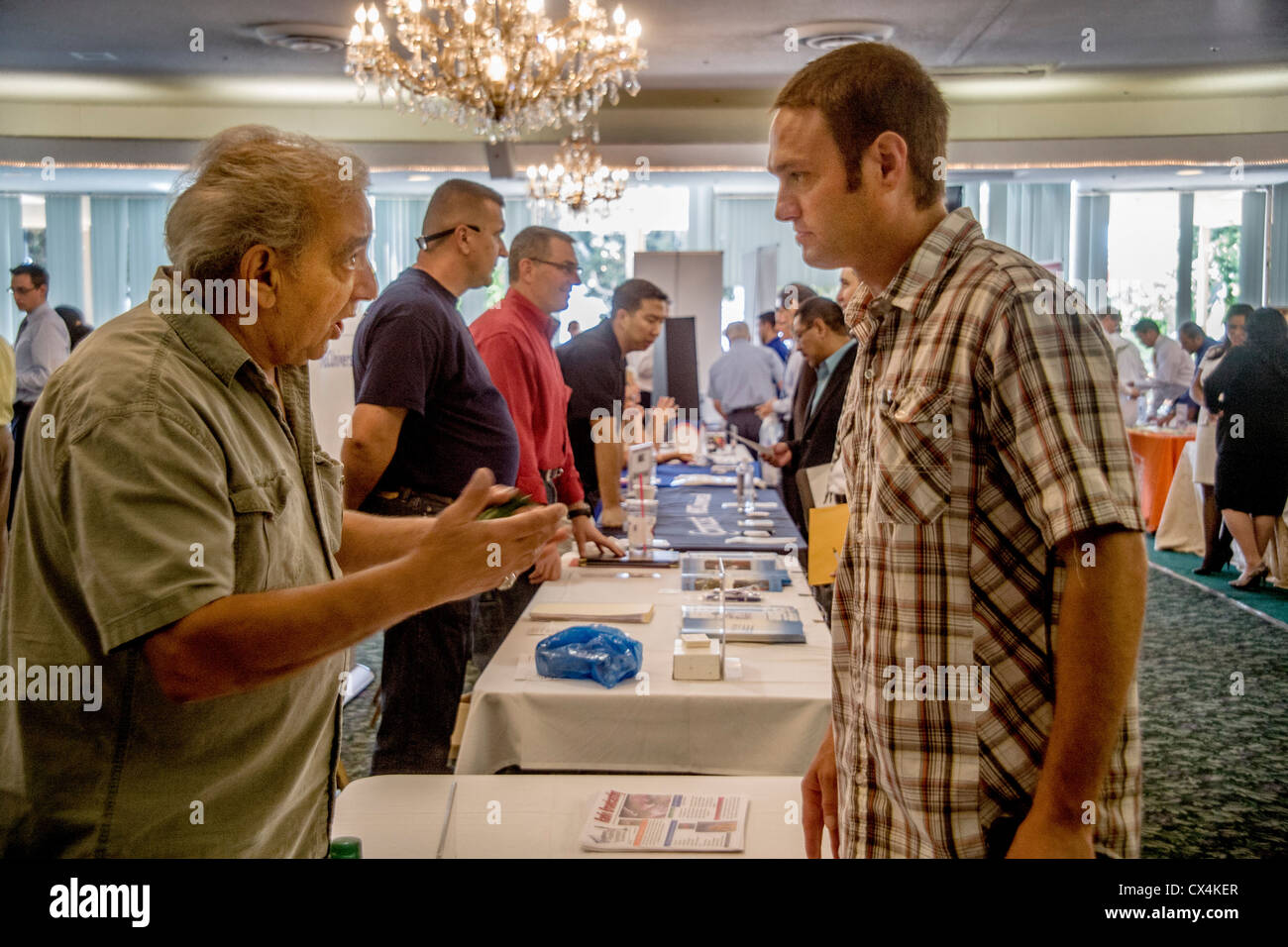 A young man discusses employment possibilities at a job fair for ...