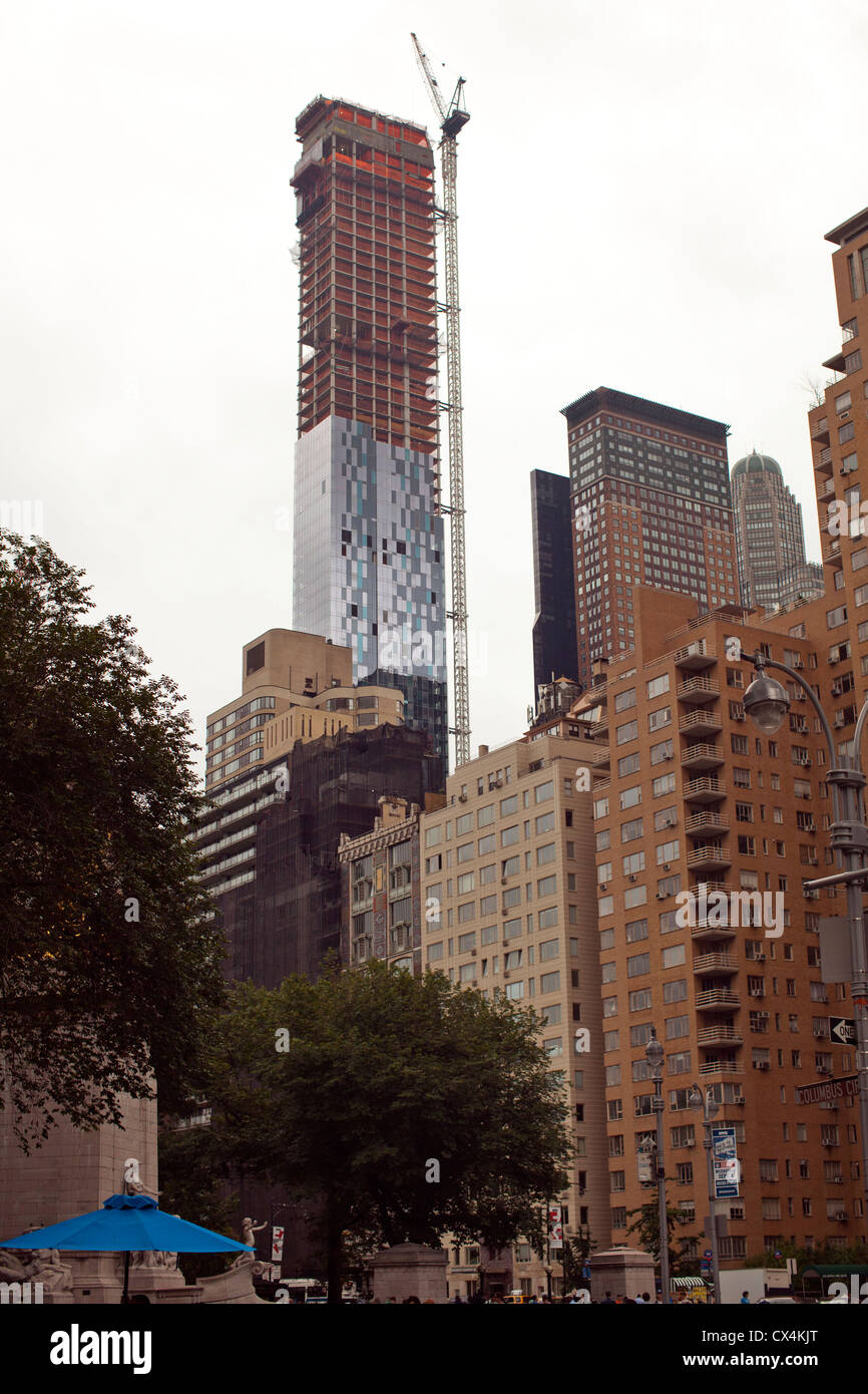 A tall, narrow residential apartment building, One57, is under ...