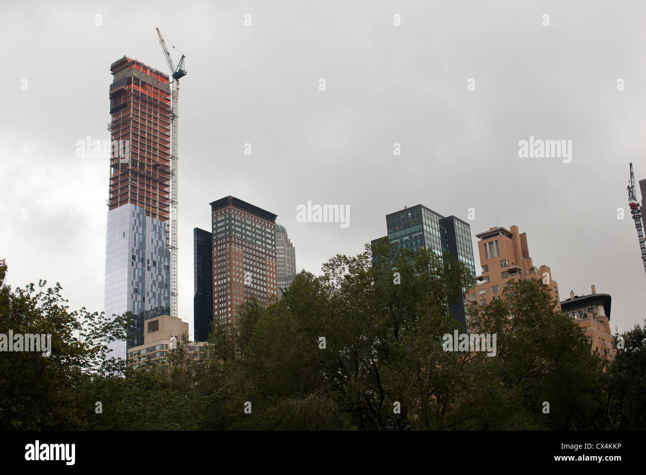 A tall, narrow residential apartment building, One57, is under ...