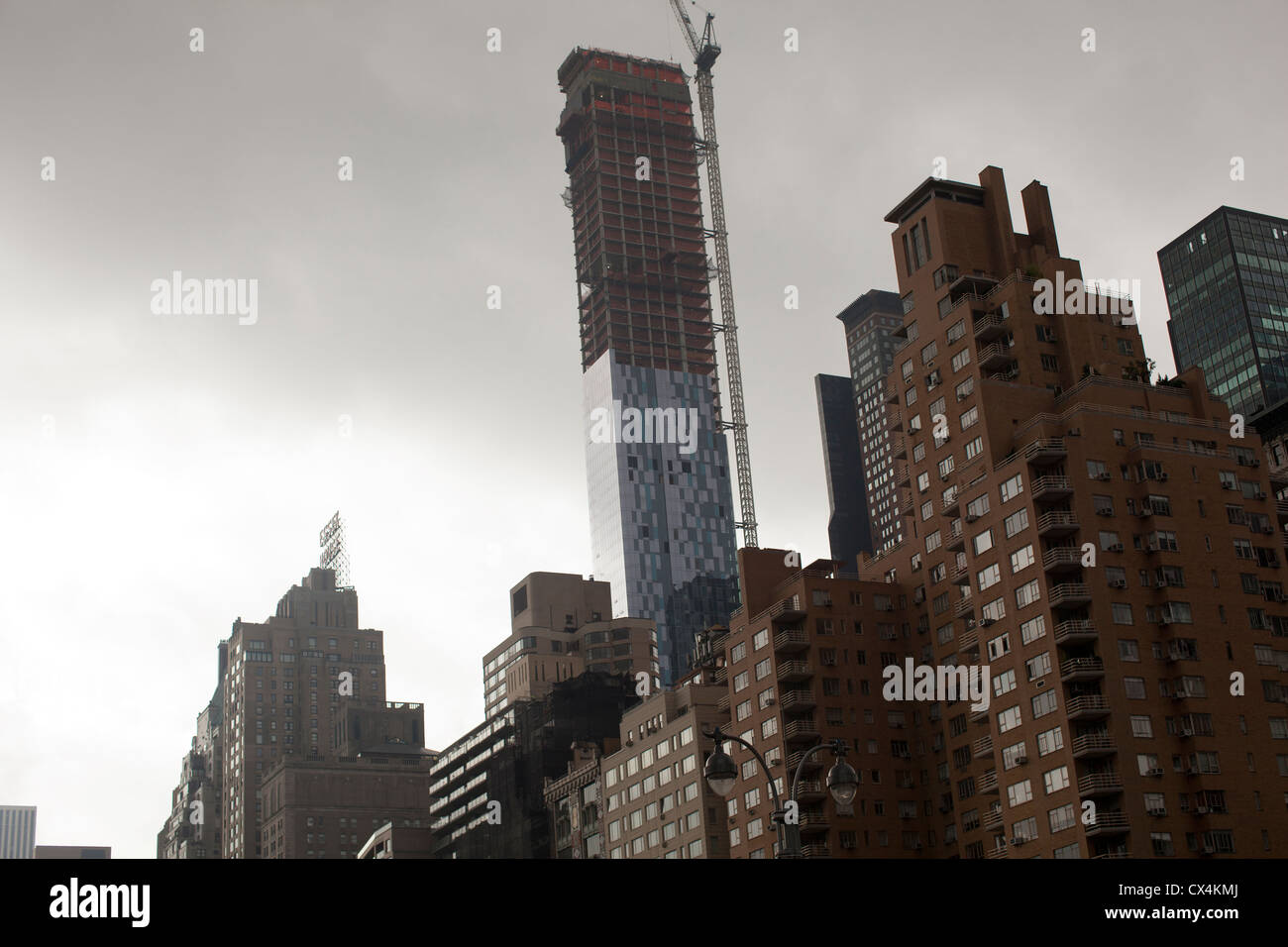 A tall, narrow residential apartment building, One57, is under ...