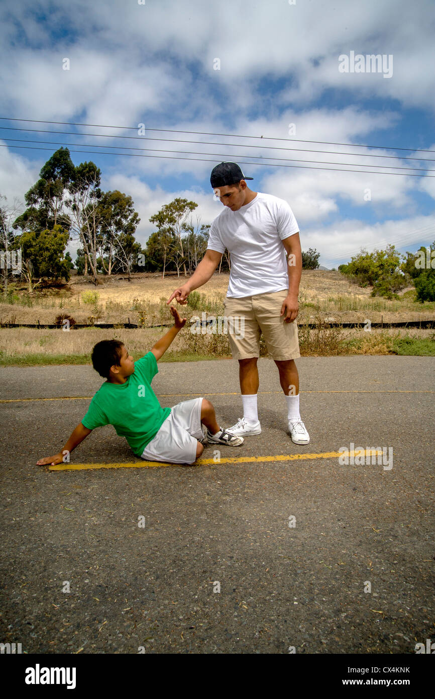 A Caucasian bully talks angrily to a Hispanic boy Stock Photo - Alamy