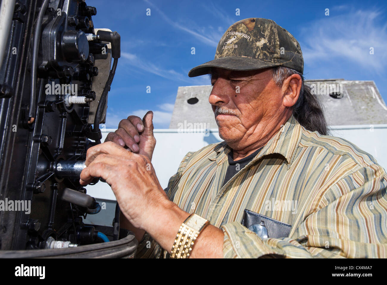 Louis Ladouceur fixing his outboard motor, a first nation resident of ...
