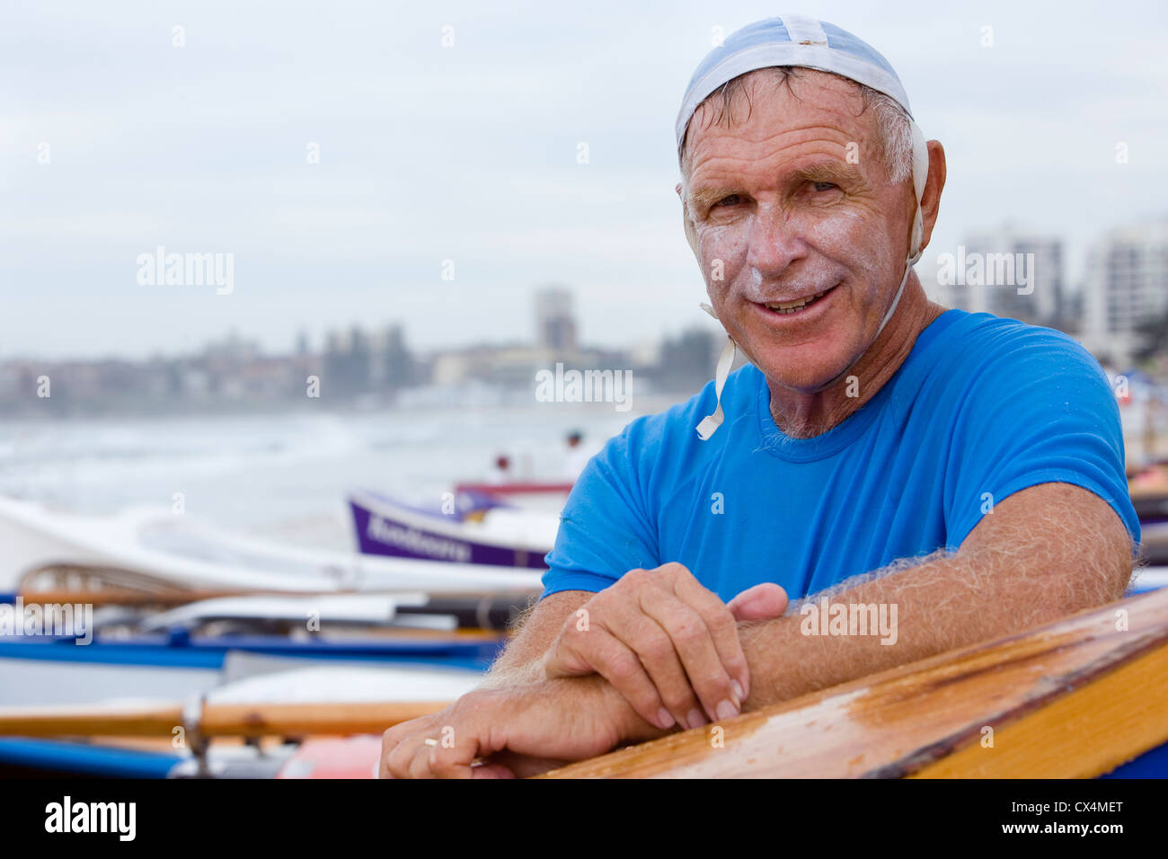 A veteran lifesaver wearing an iconic swim cap and zinc cream, at ...