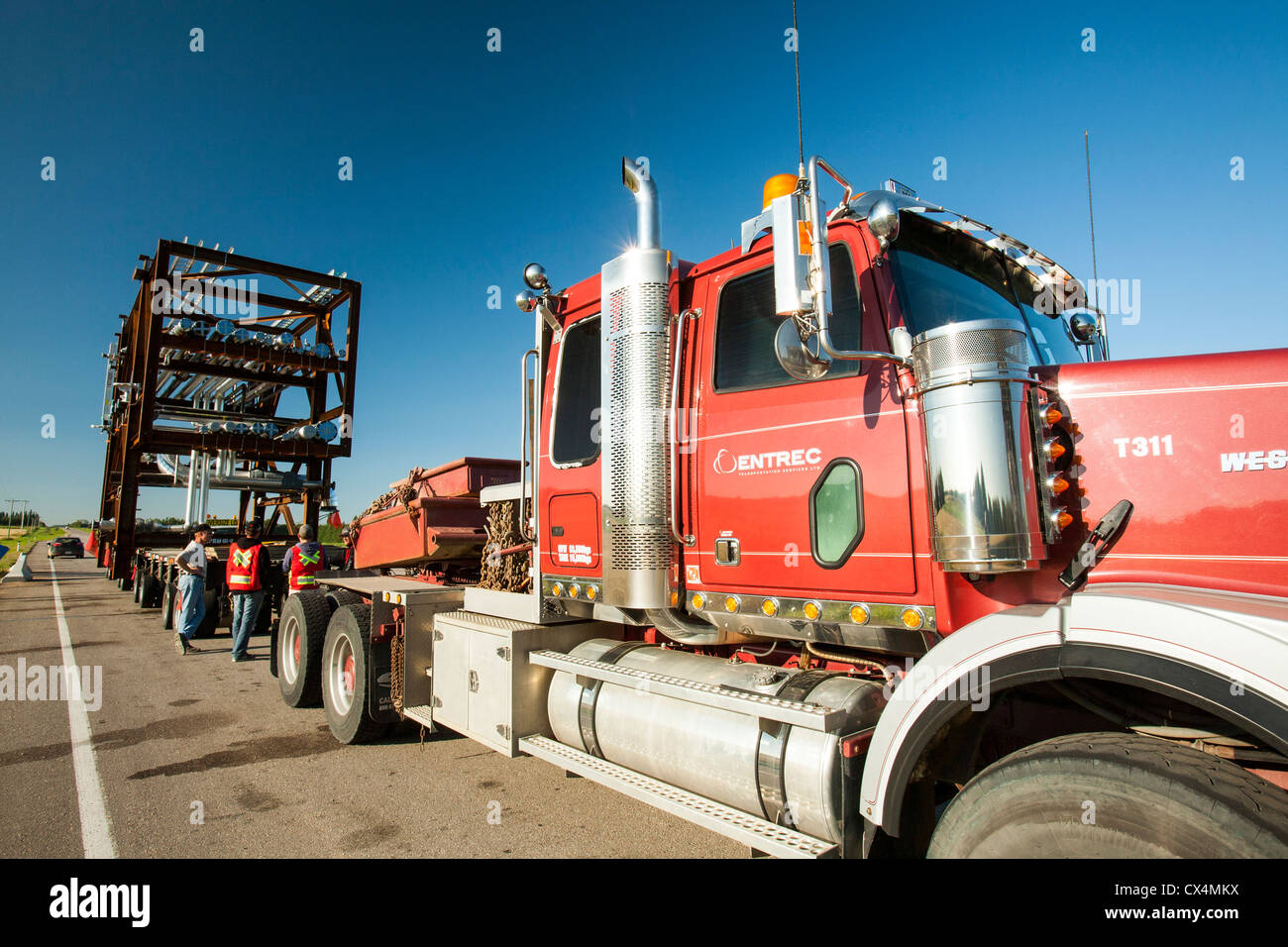 Trucks haul an oversize load of tar sands equipment for a SAG D mine ...