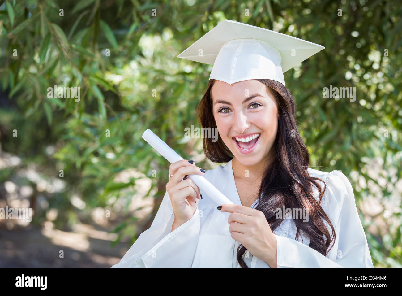 Attractive Mixed Race Girl Celebrating Graduation Outside In Cap and ...