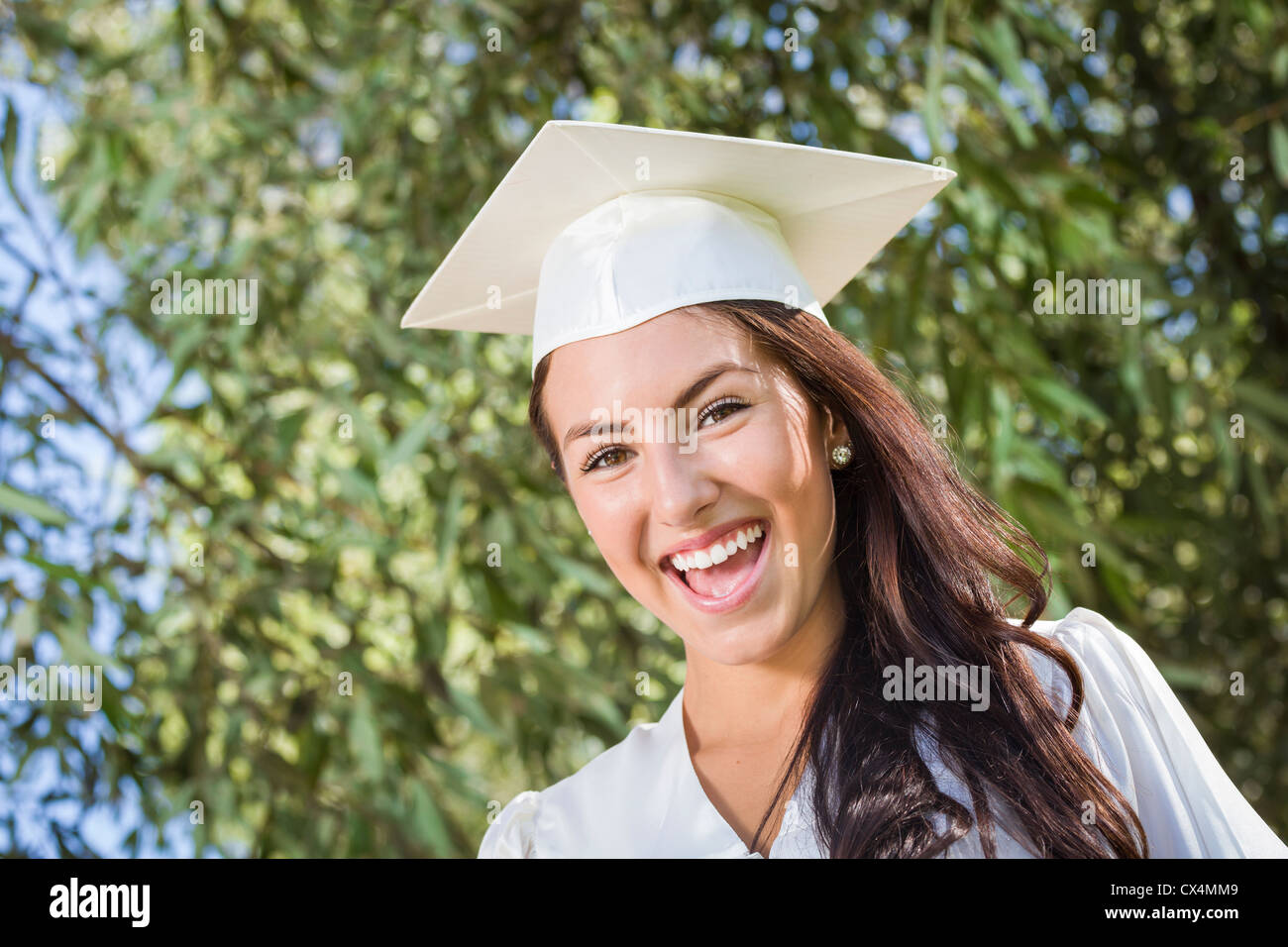 Attractive Smiling Mixed Race Girl Celebrating Graduation Outside In ...