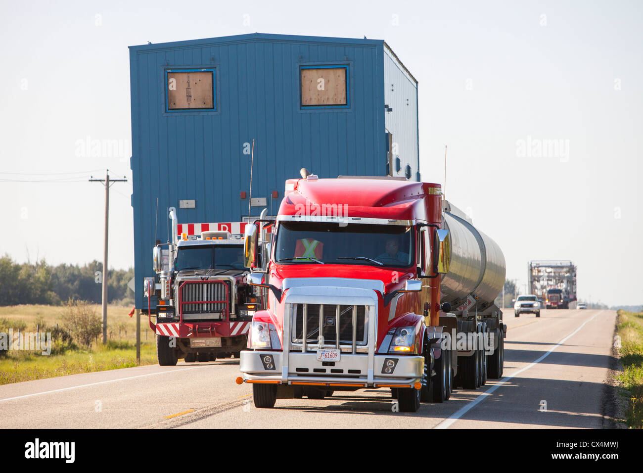 Trucks haul an oversize load of tar sands equipment for a SAG D mine ...