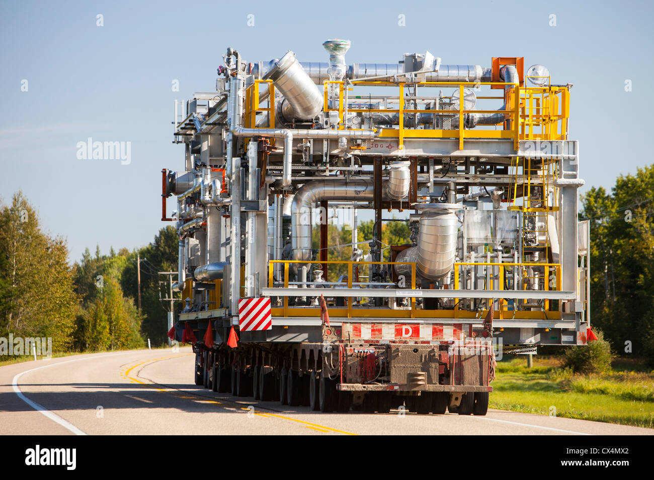 Trucks haul an oversize load of tar sands equipment for a SAG D mine ...