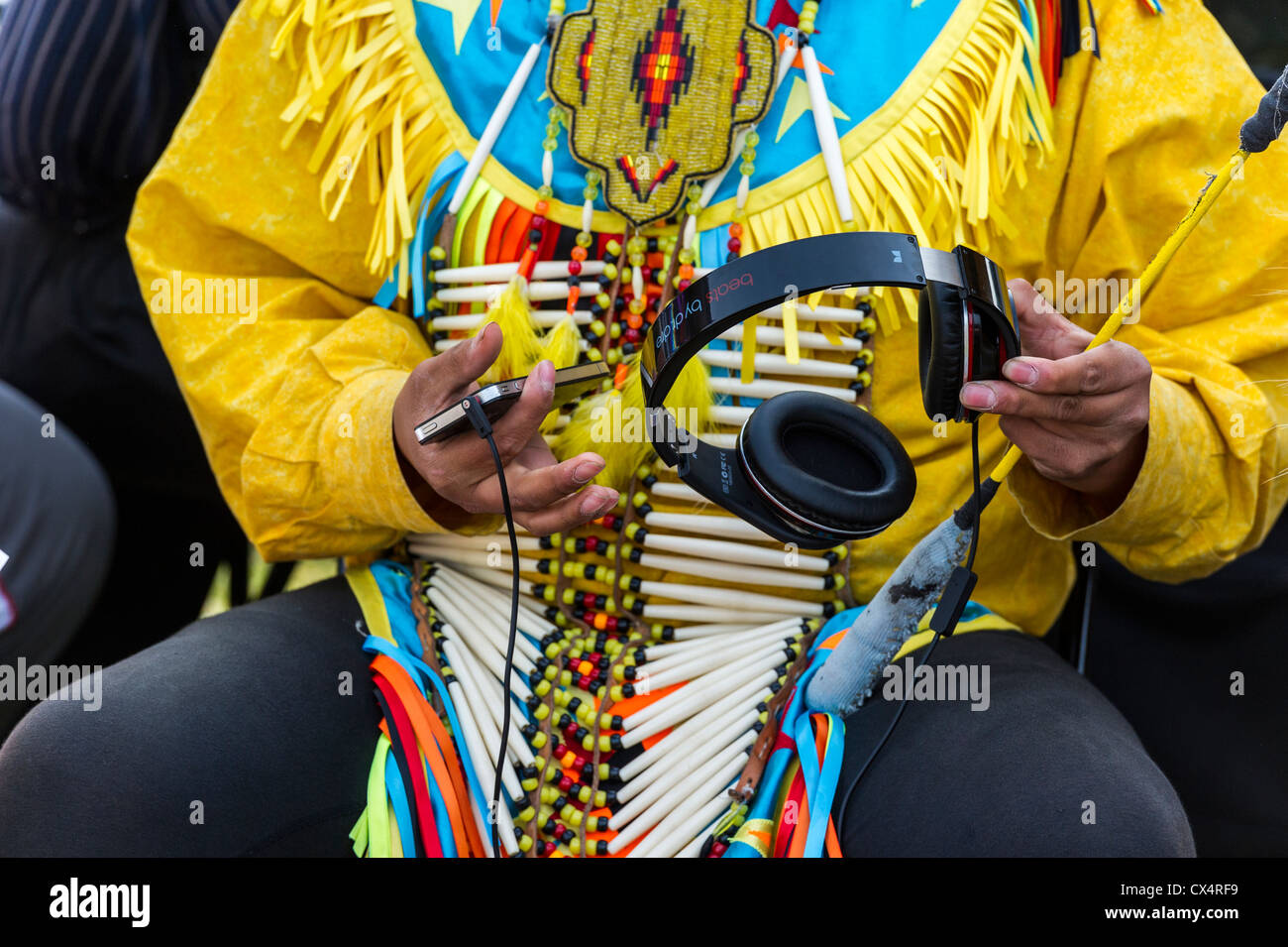 Native drummer with MP3 player at the Treaty 7 First Nations Powwow ...