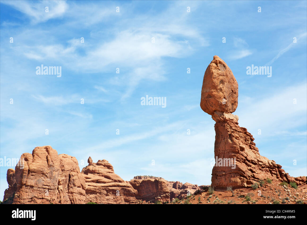 Arches National park balancing rock at during day against dramatic sky ...