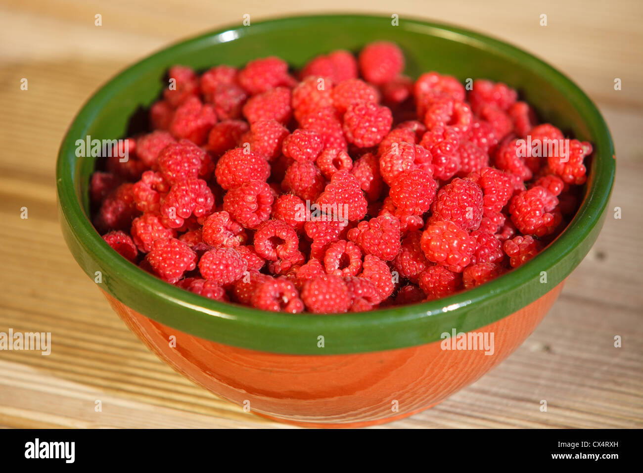 Bowl full of raspberries Stock Photo - Alamy