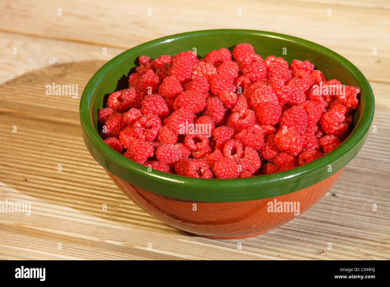 Bowl full of raspberries Stock Photo - Alamy