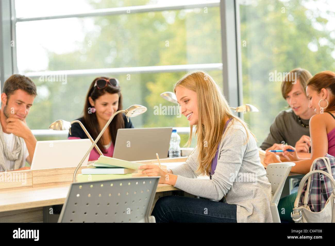 High-school students studying in library together academic teenagers ...