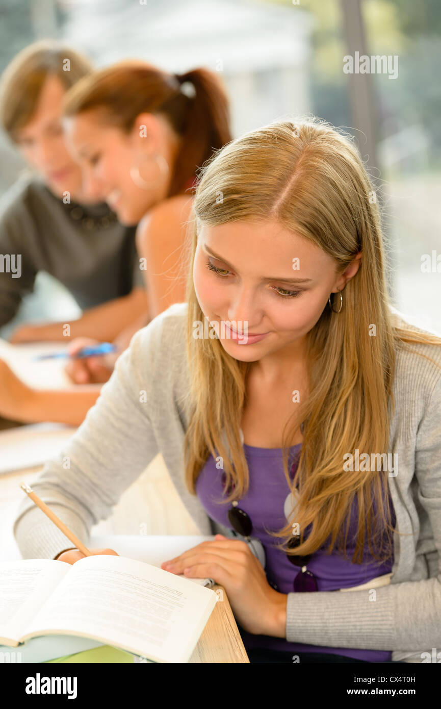 High-school student taking notes in library study academic campus ...