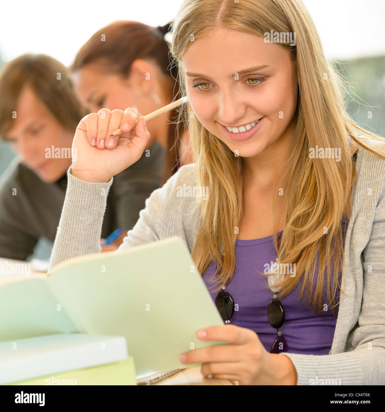 High-school student taking notes in library study academic campus ...