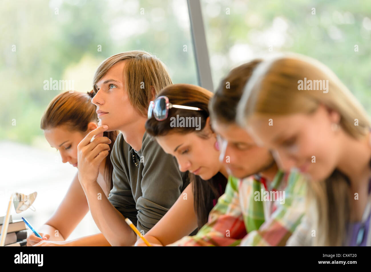 High-school student thinking at exam class teens writing college study ...