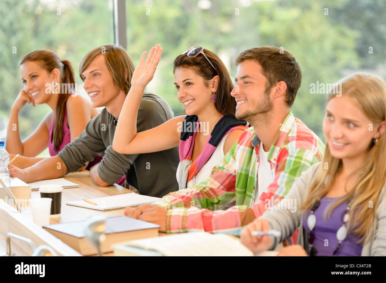 High-school student raising her hand in class lesson teenagers study ...